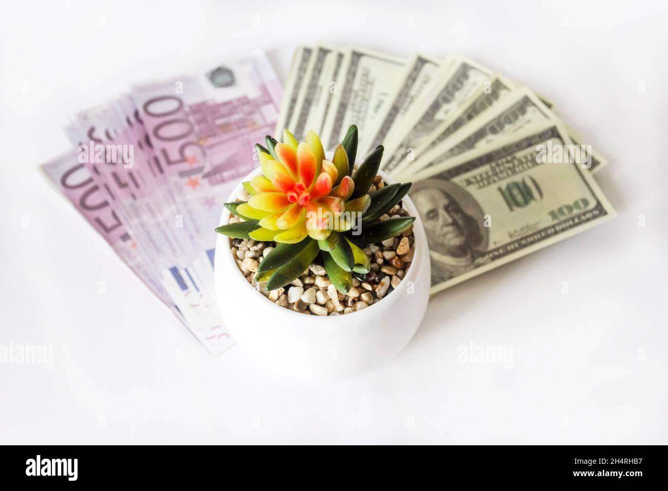 Set of euro and dollar banknotes out of focus. In the foreground, a ...