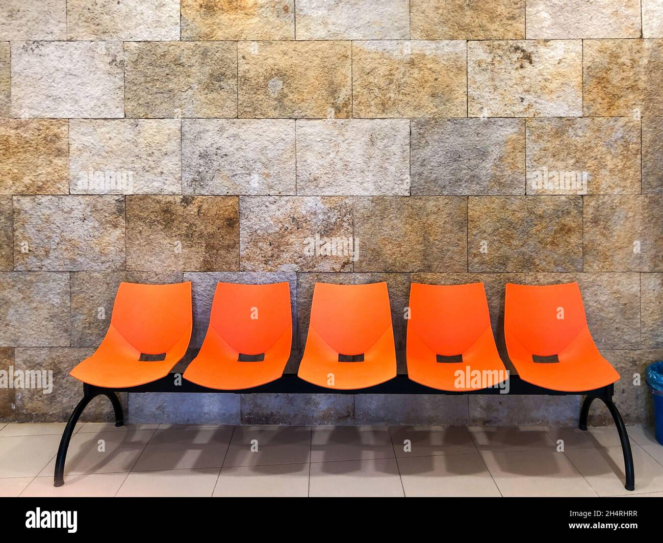 Closeup shot of orange benches in a waiting room Stock Photo - Alamy