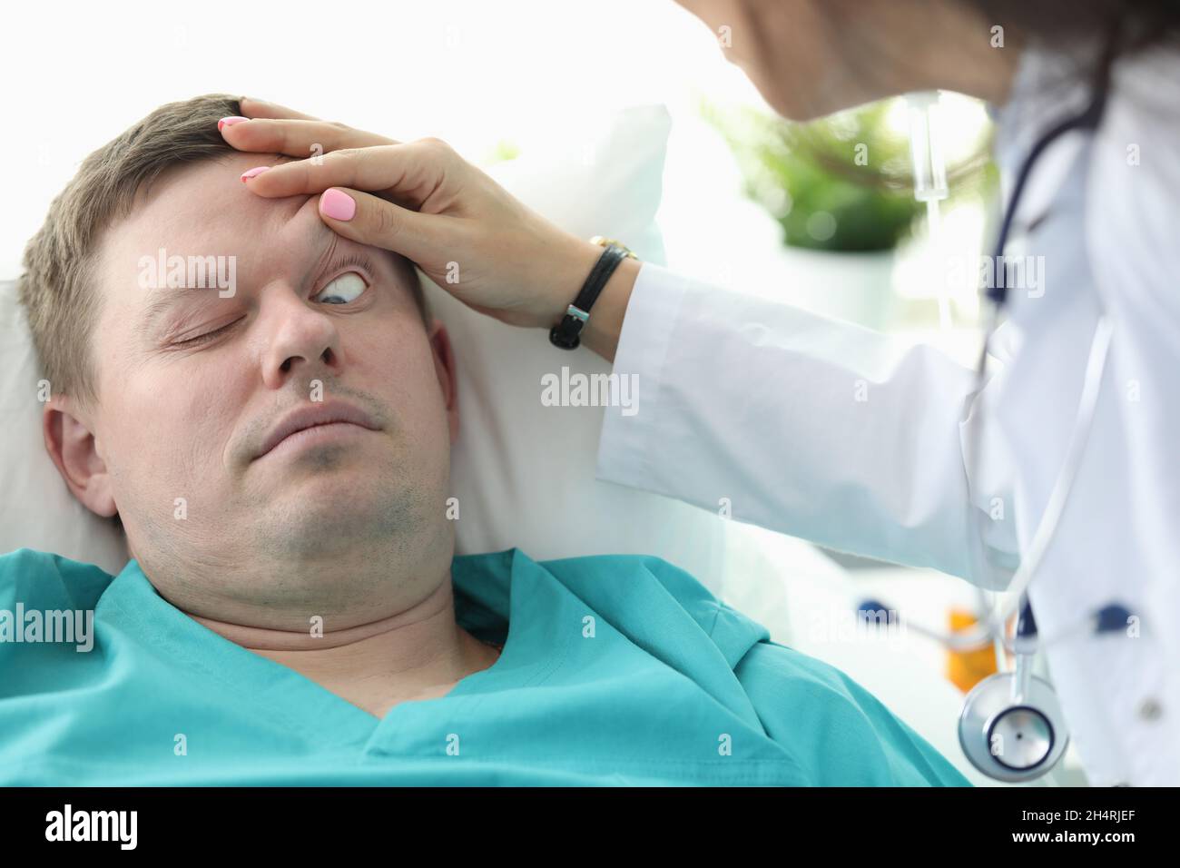Doctor opens his eyes to patient unconscious clinic Stock Photo - Alamy