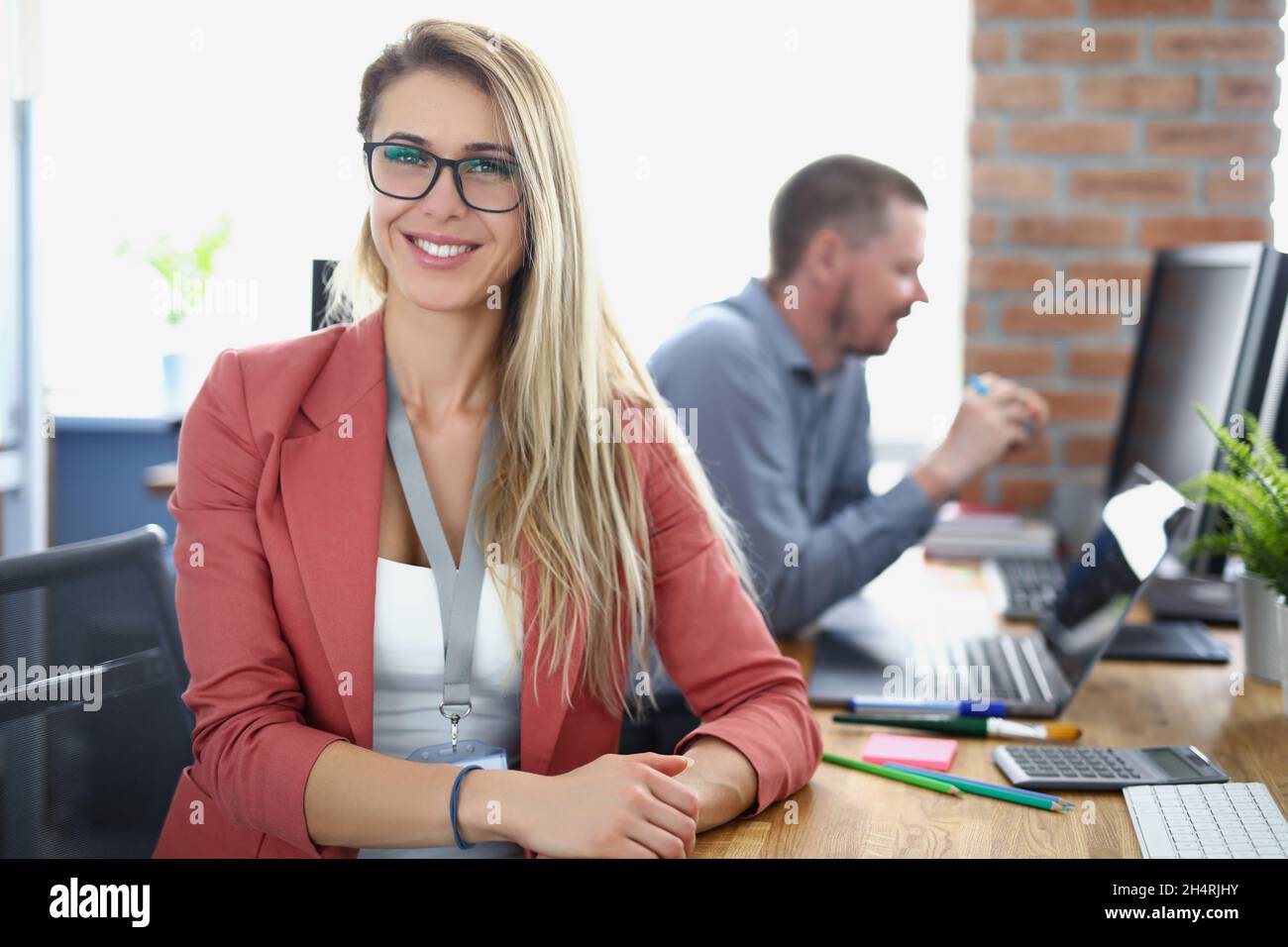 Portrait of attractive woman in presentable outfit on working place ...