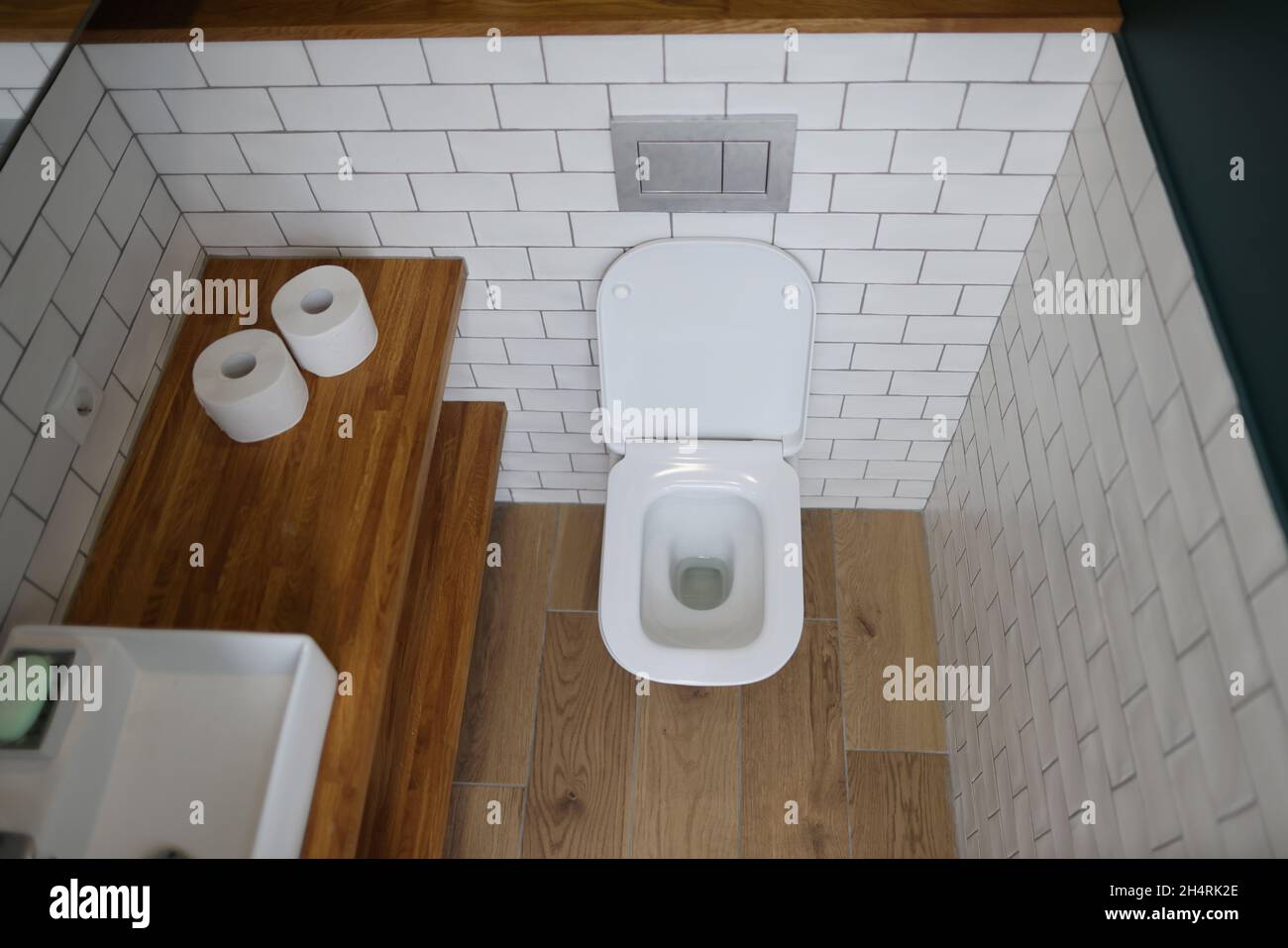 Top view of modern bathroom interior with wooden shelves, white sink ...