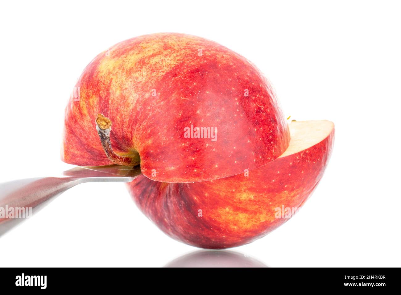 Two halves of a sweet juicy apple with a metal knife, close-up ...