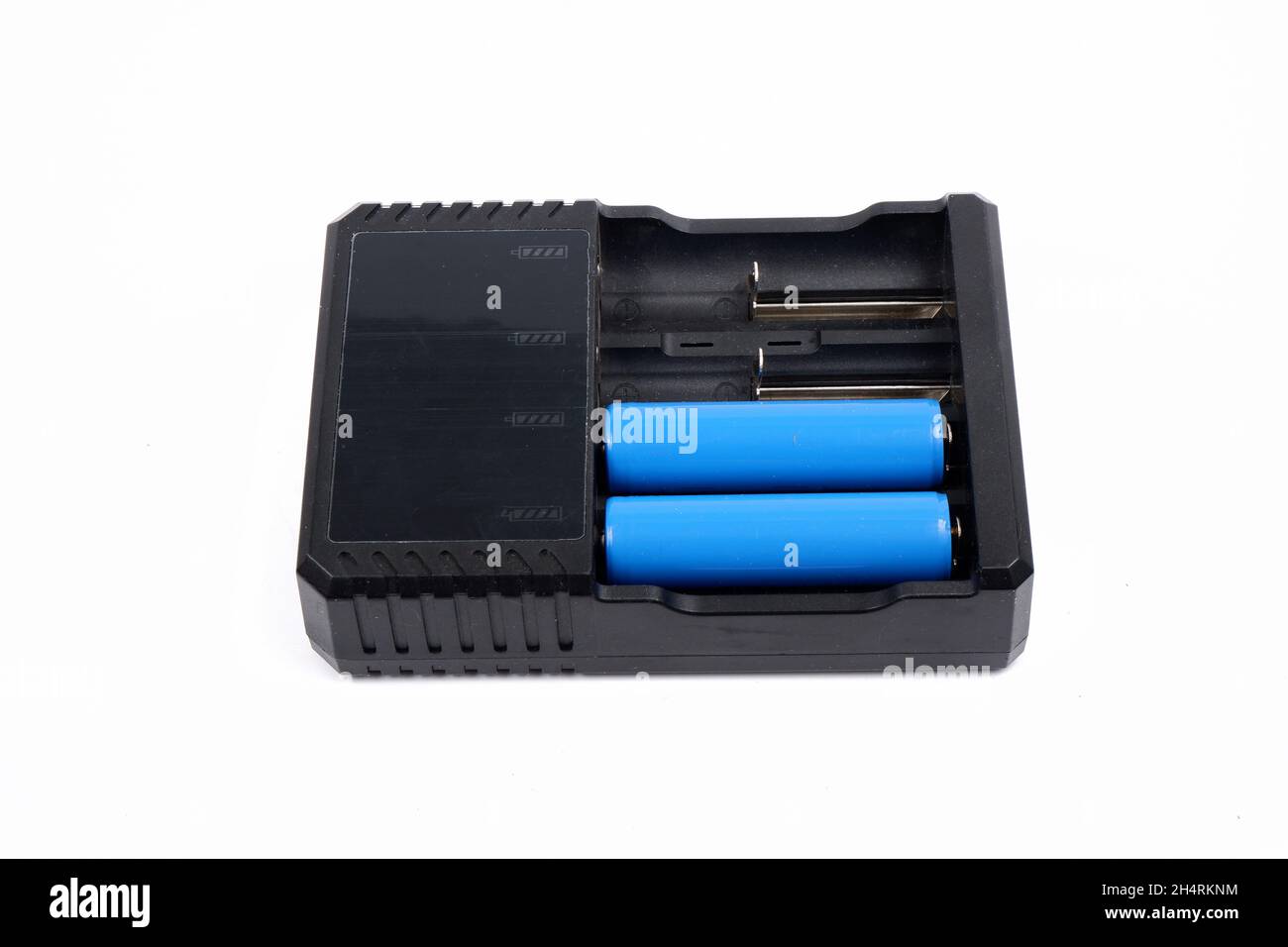battery charger, with two batteries in it, isolated on a white ...