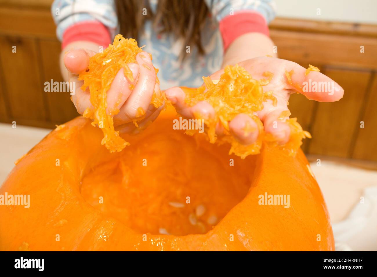 Young girl holding pumpkin pulp.uk Stock Photo - Alamy