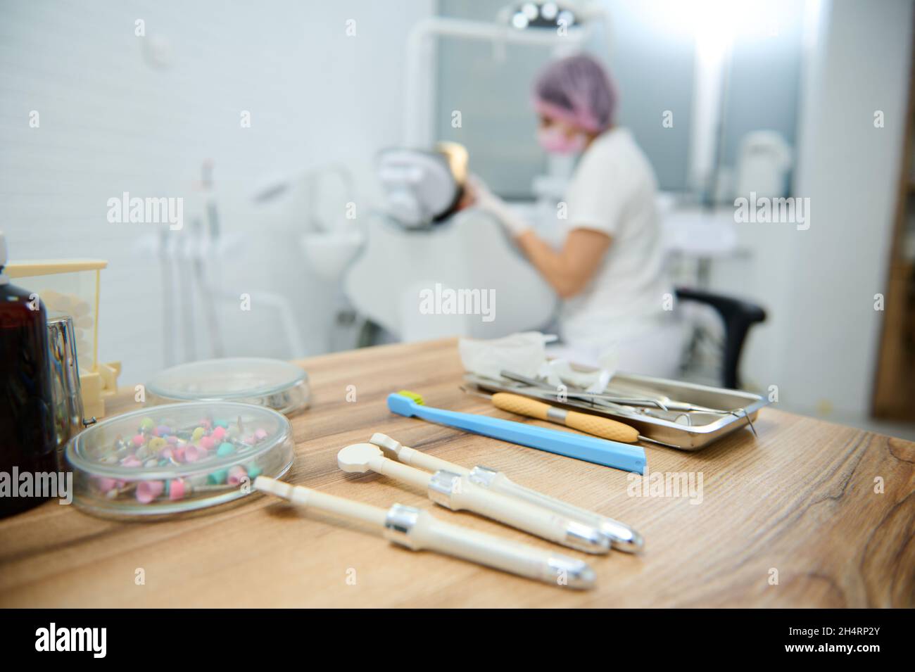 Modern dental tools, sterile stainless steel instruments on a wooden ...