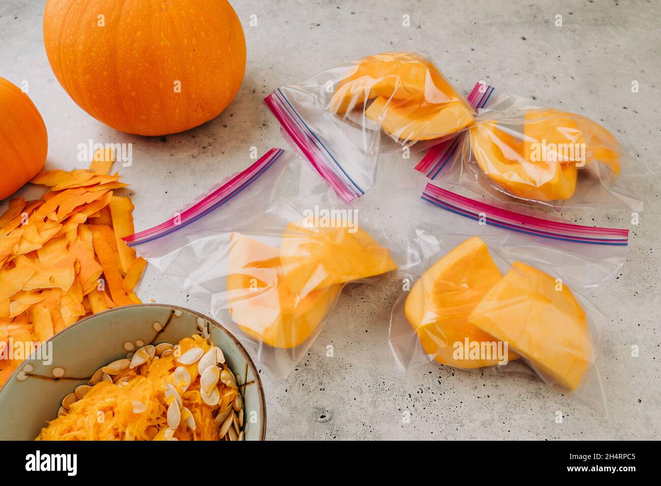 Fresh raw peeled pumpkin slices in zip lock bags close up, ready to be ...