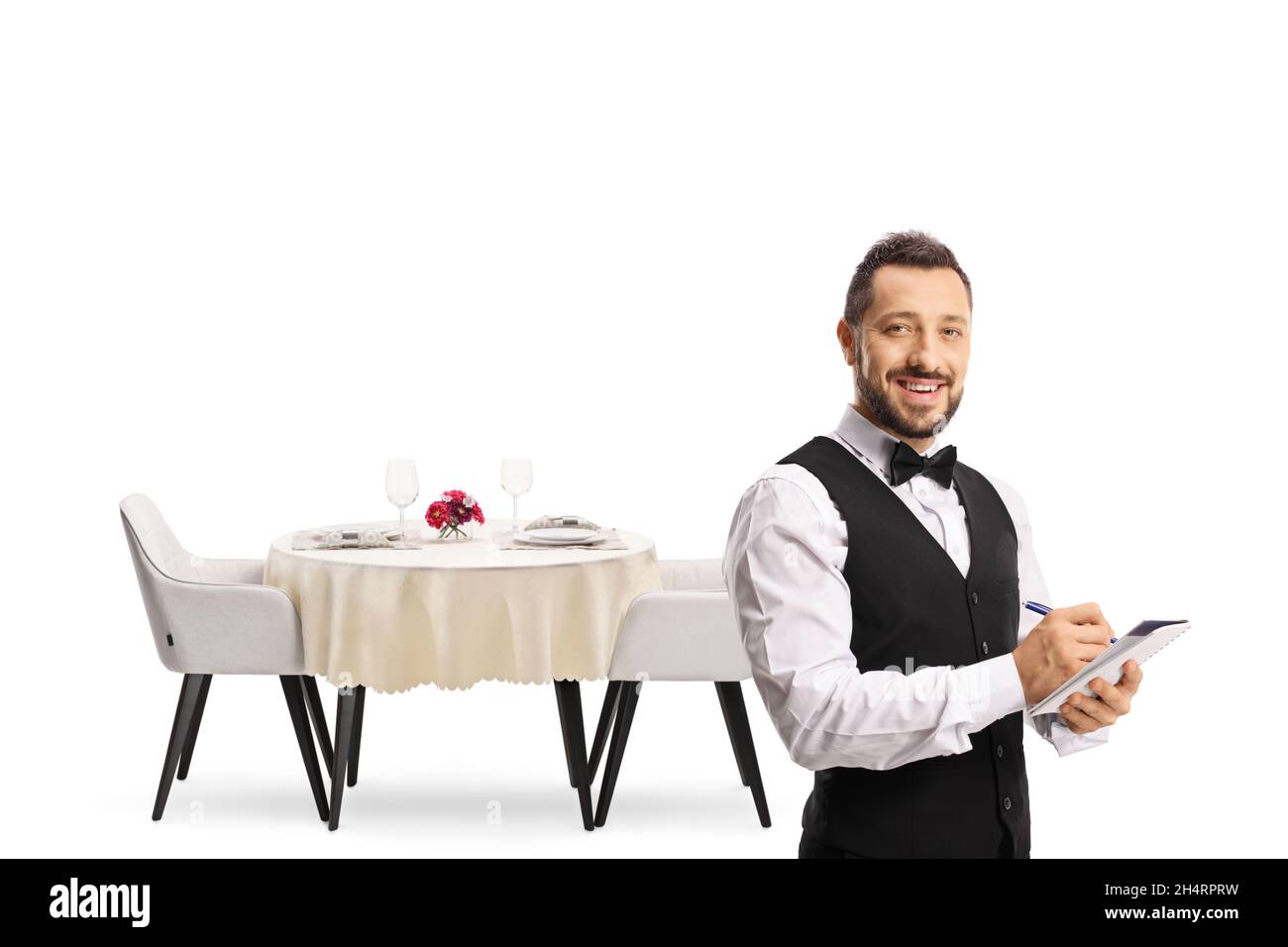Server with a bow tie taking an order and standing in front of a table ...