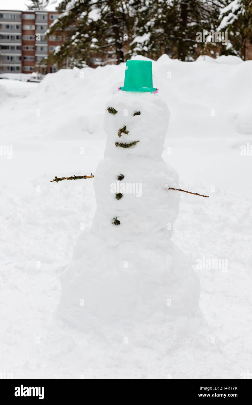 Snowman made by children with natural materials and little bucket Stock ...