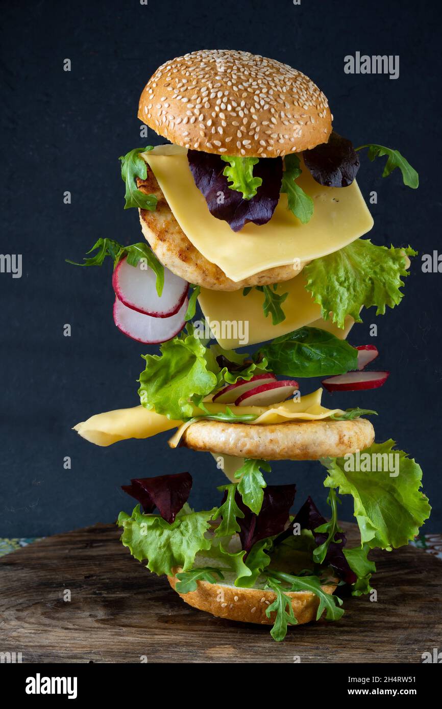 Levitating burger slices. Flying food. Hamburger bun, double chicken ...