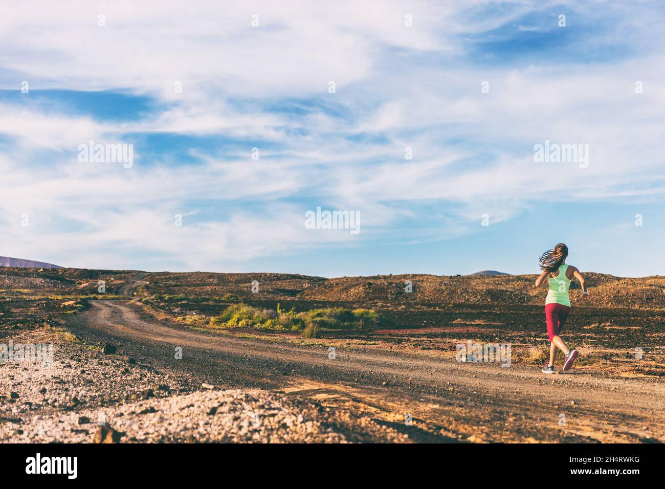 Fitness training in outdoor landscape volcano. Athlete woman running on ...