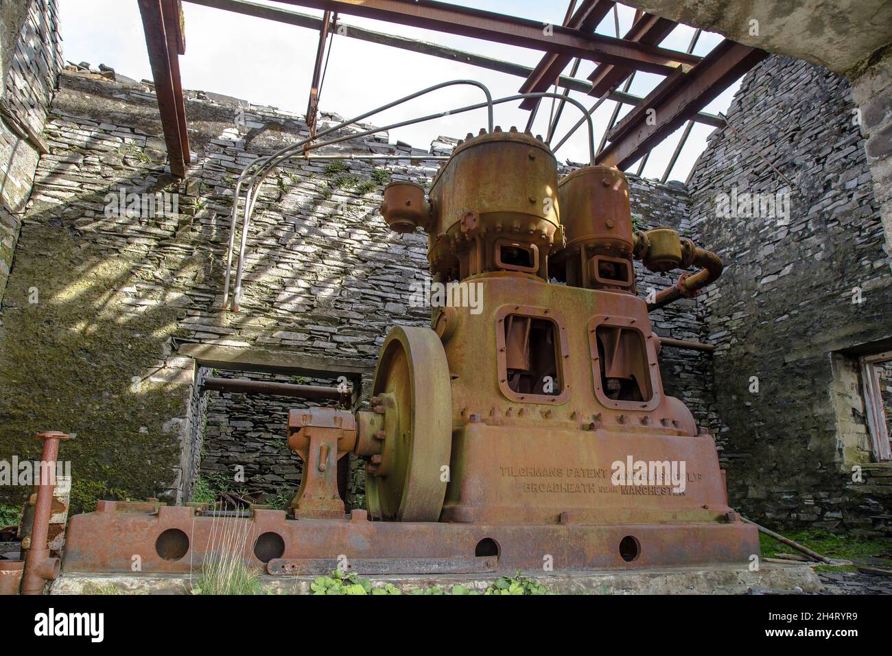 Old machinery in derelict, disused slate quarry building, North Wales ...