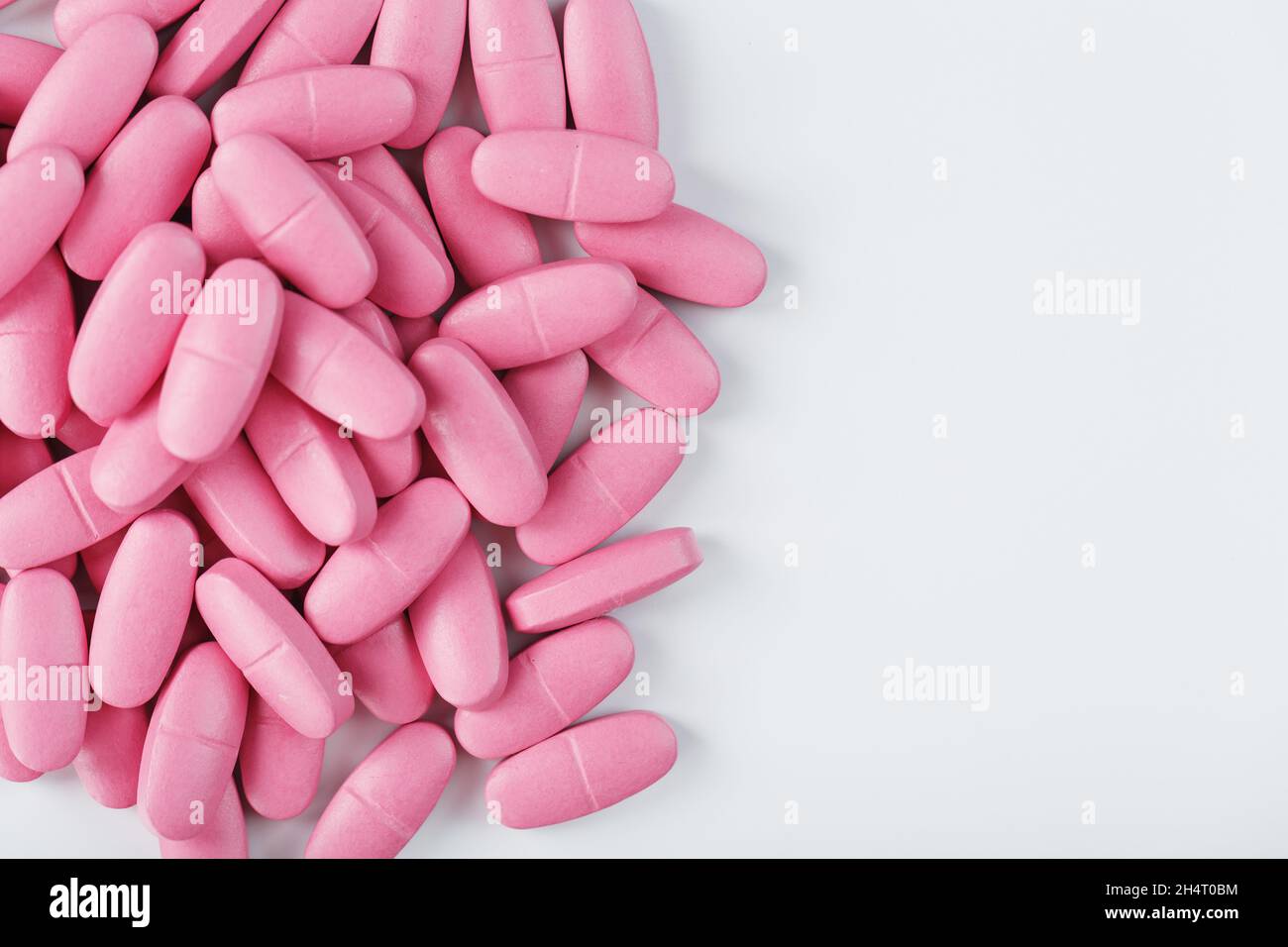Pink vitamin pills for women on a white background. Multivitamins for ...
