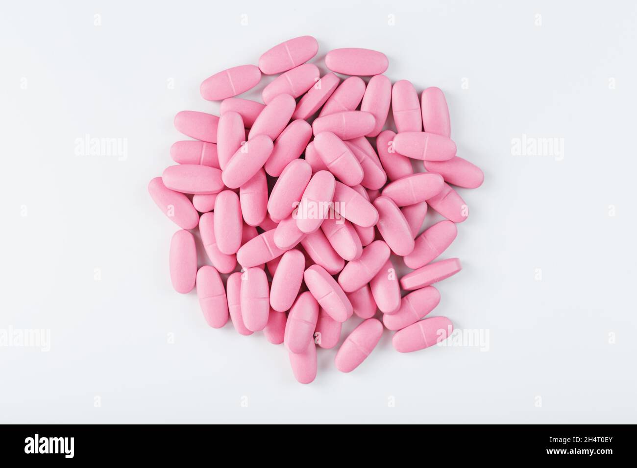 Pink vitamin pills for women on a white background. Multivitamins for ...