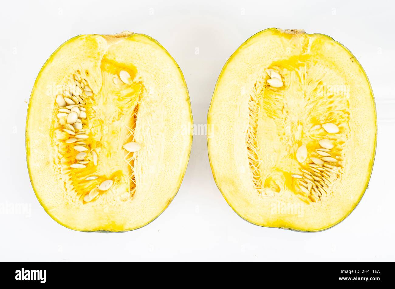 Small round pumpkin cut in half on white background. Studio Photo Stock ...