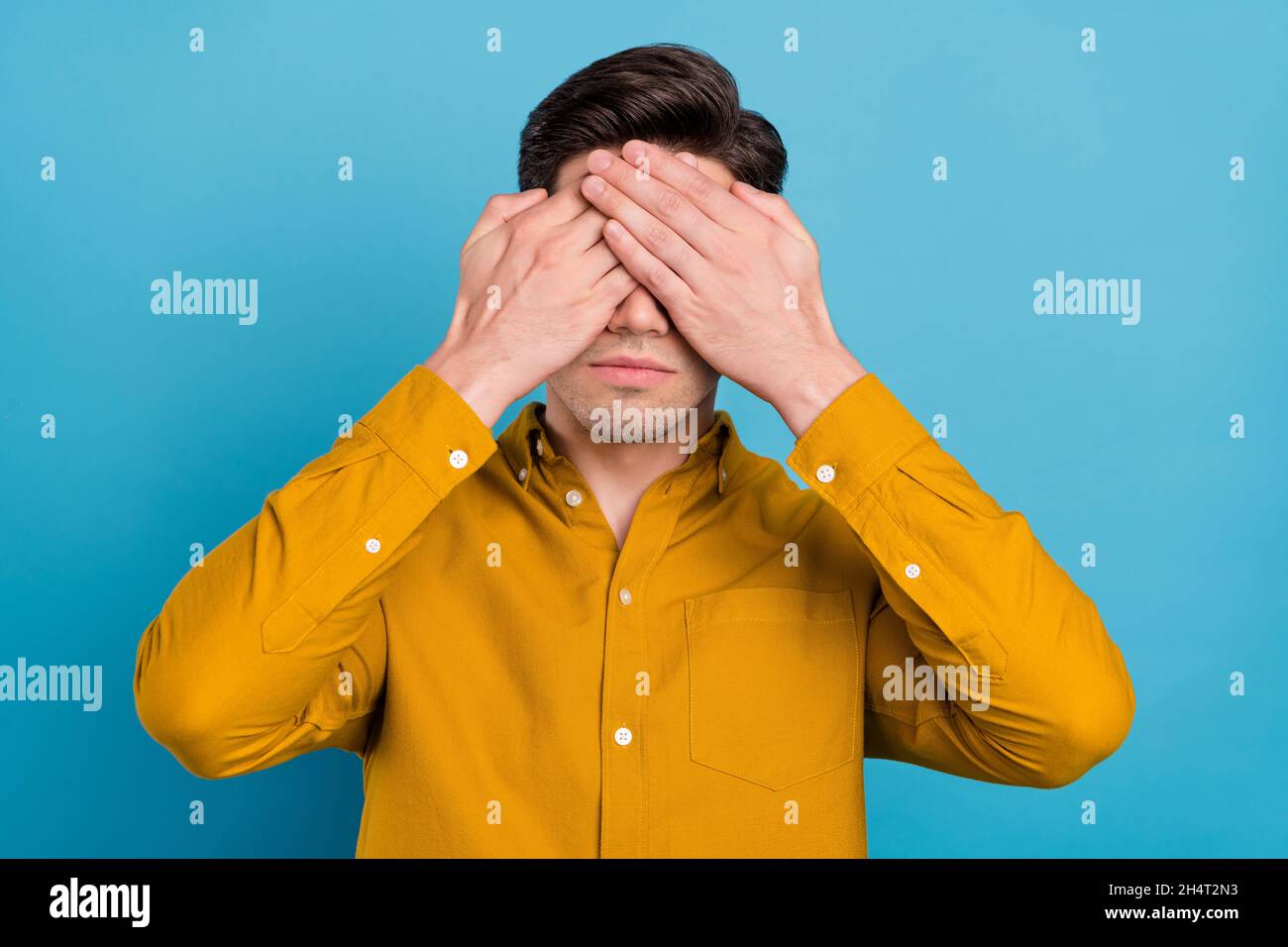 Photo of serious unhappy young man wear yellow shirt arms cover eyes ...