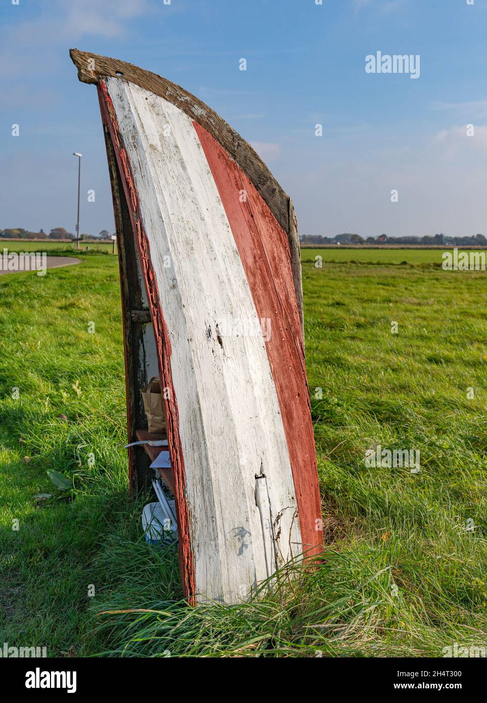 close-up of a part of an old weathered boat which is rebuilt as a sales ...