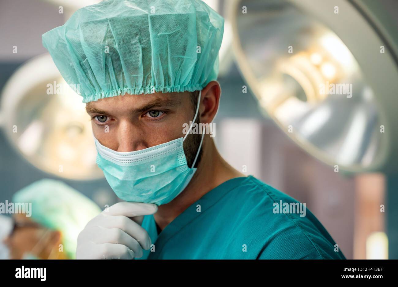 Portrait of a tired male surgeon at workin hospital. Healthcare ...