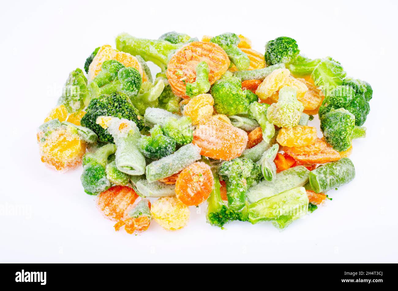 Pile of frozen raw vegetable pieces isolated on white background ...