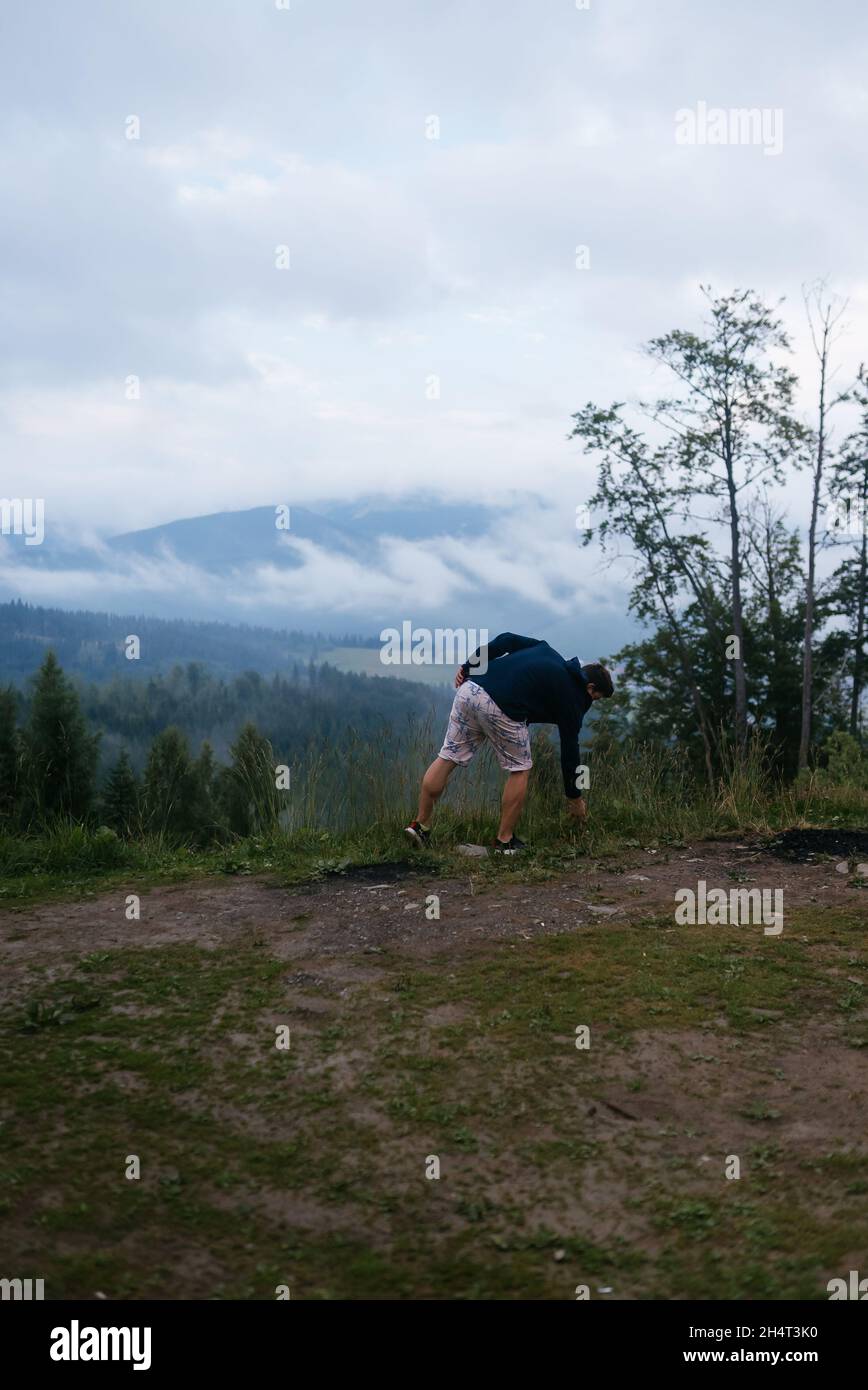 Guy top of a hill enjoying view of nature Stock Photo - Alamy