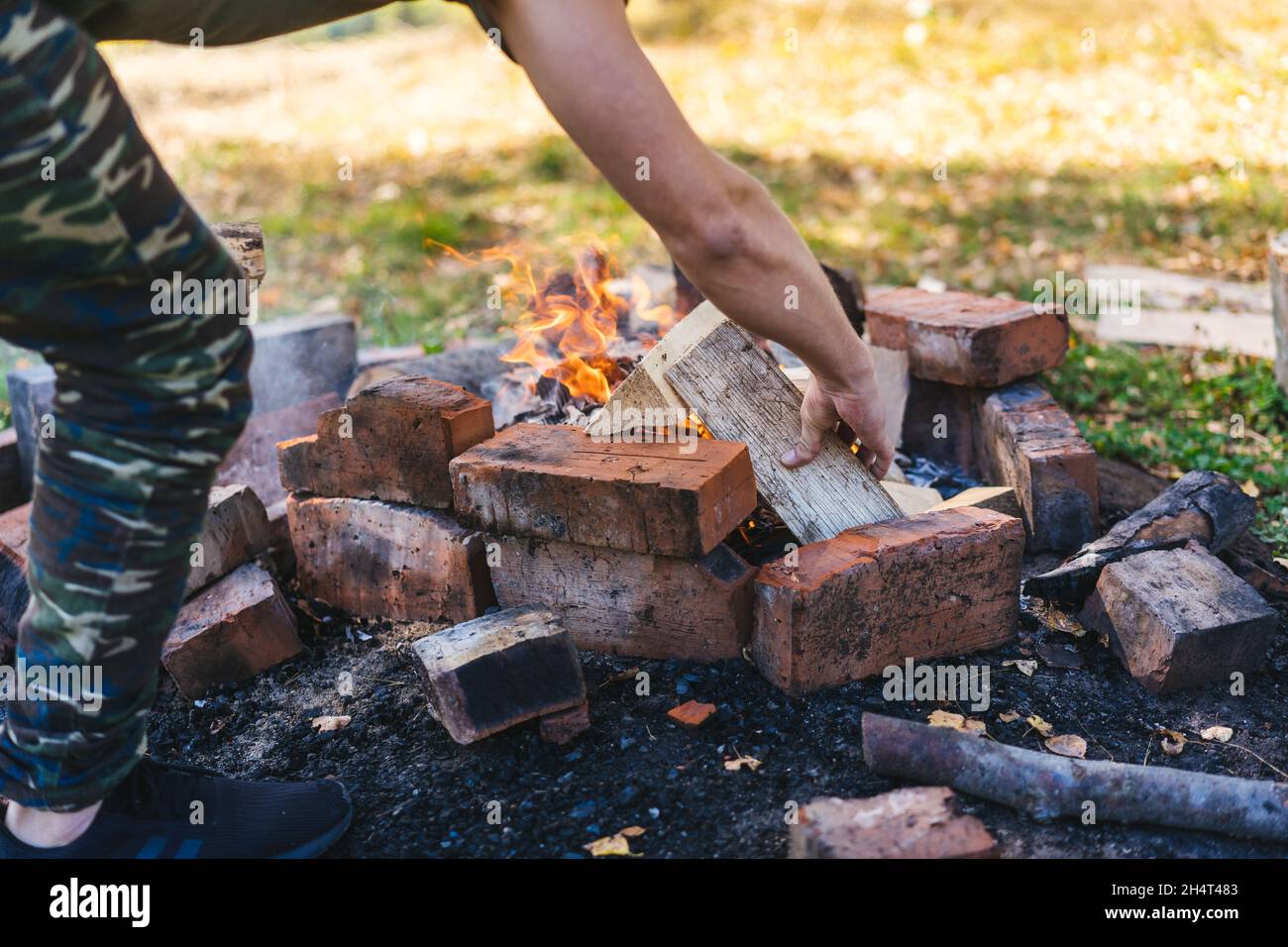 Camping open bonfire burning in circle of stones Stock Photo - Alamy