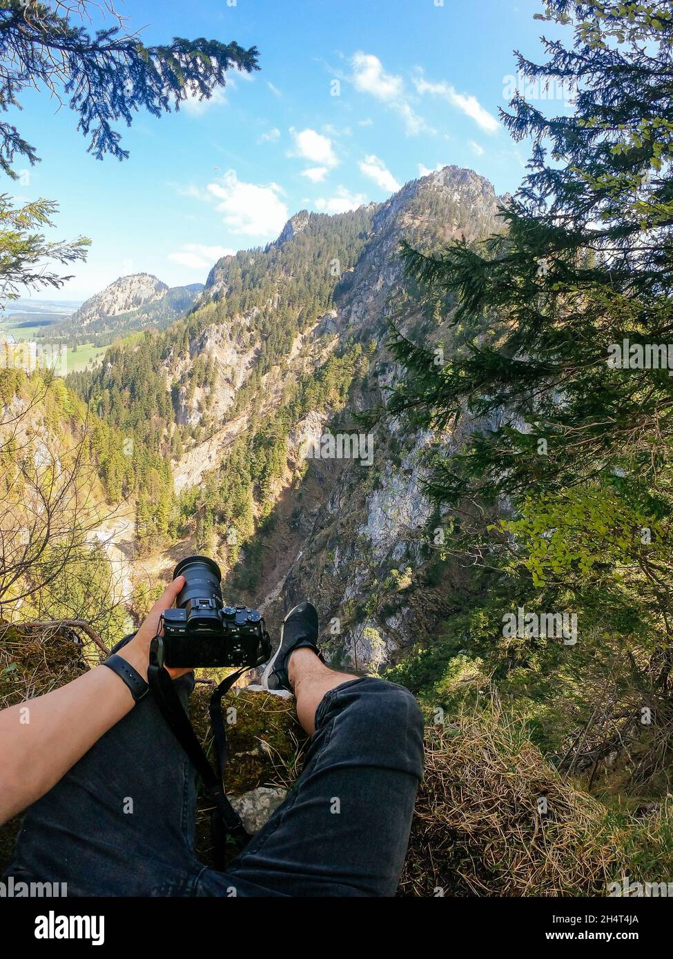 A photographer observes with his camera in hand from the top of a ...