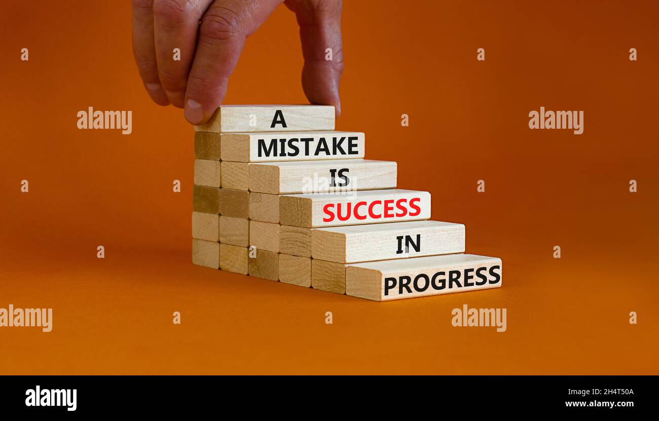 Mistake or success symbol. Wooden blocks with words A mistake is ...