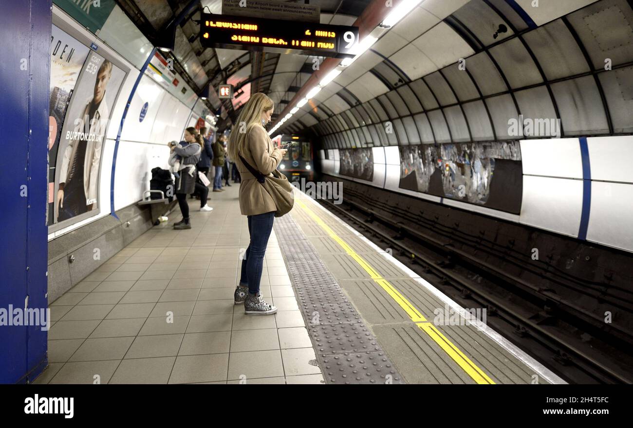 London, England, UK. DLR / Docklands Light Railway - lone woman on the ...