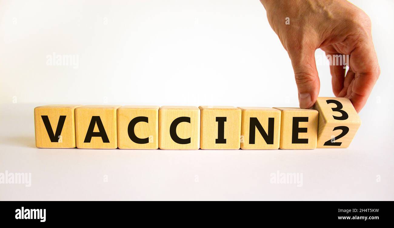 Covid-19 booster vaccine shot symbol. Doctor turns a wooden cube and ...