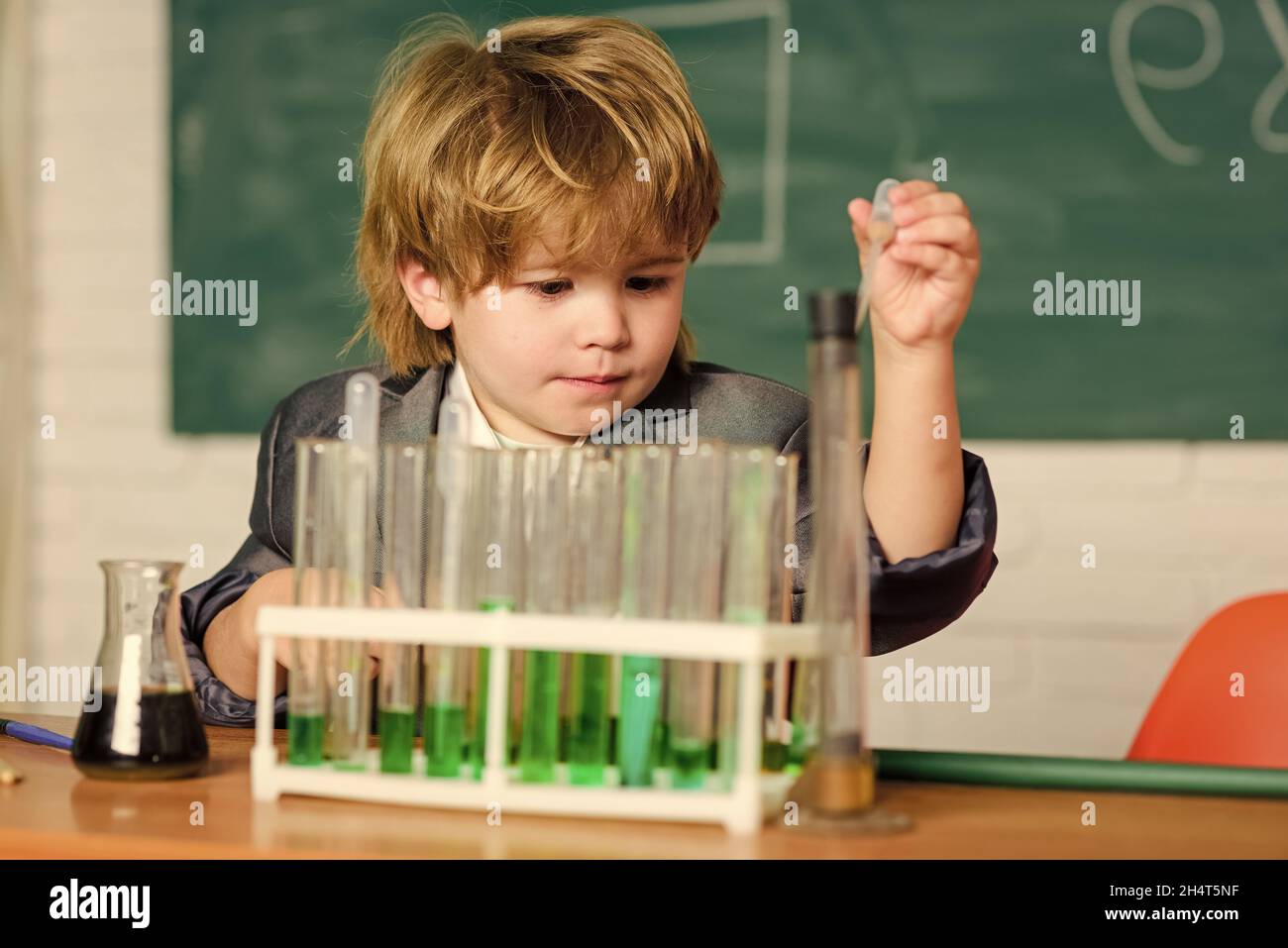 Little boy is making science experiments. school kid scientist studying ...