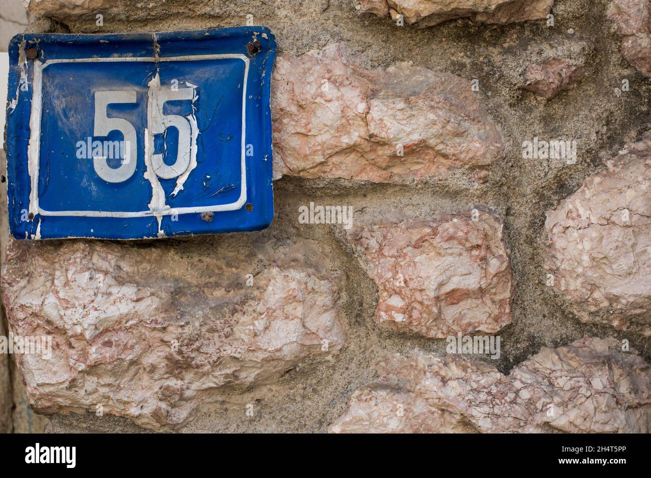 Number 55 plaque on a dirty old house wall Stock Photo - Alamy