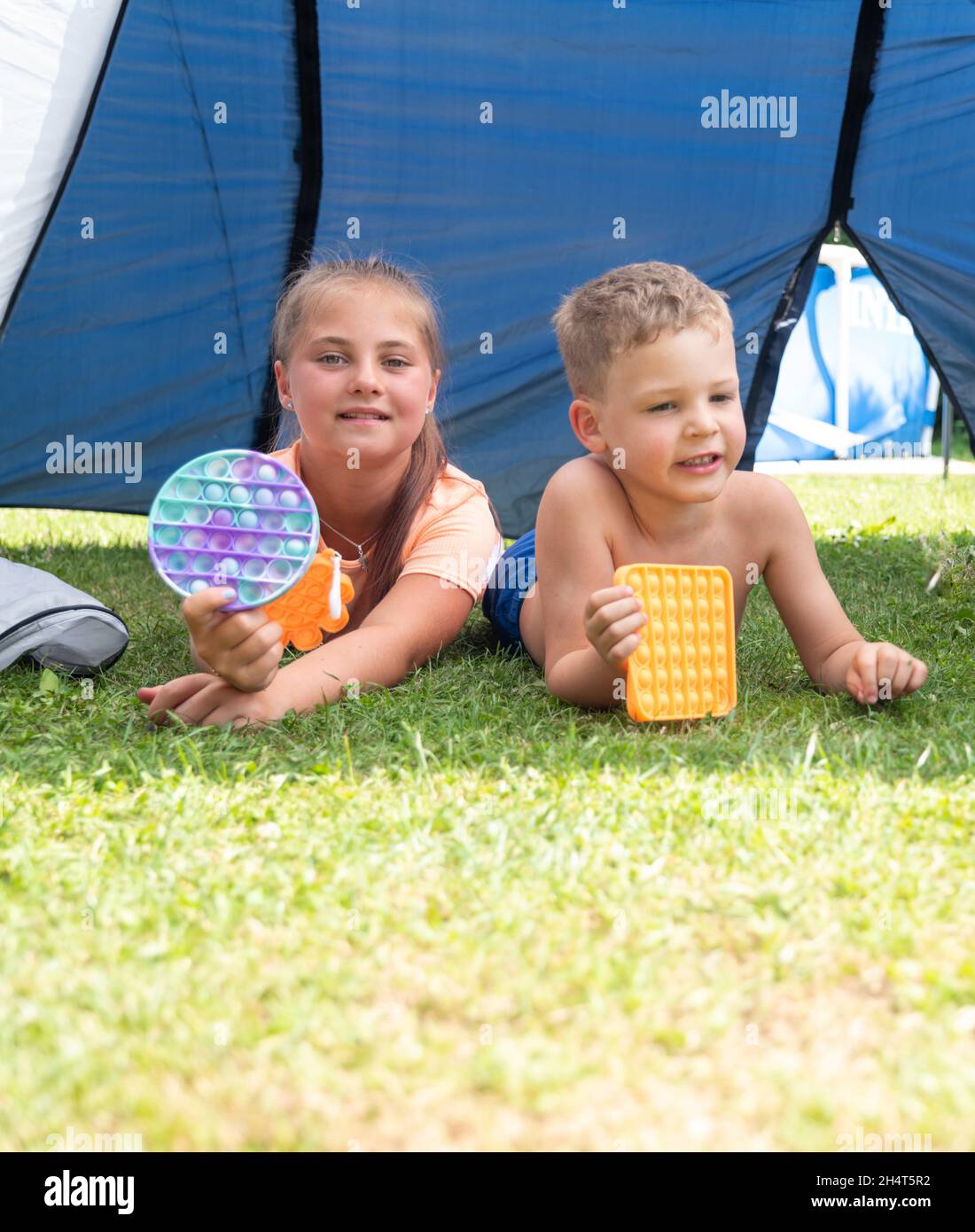 Pop it toy or board game with kids playing outdoor, development of ...