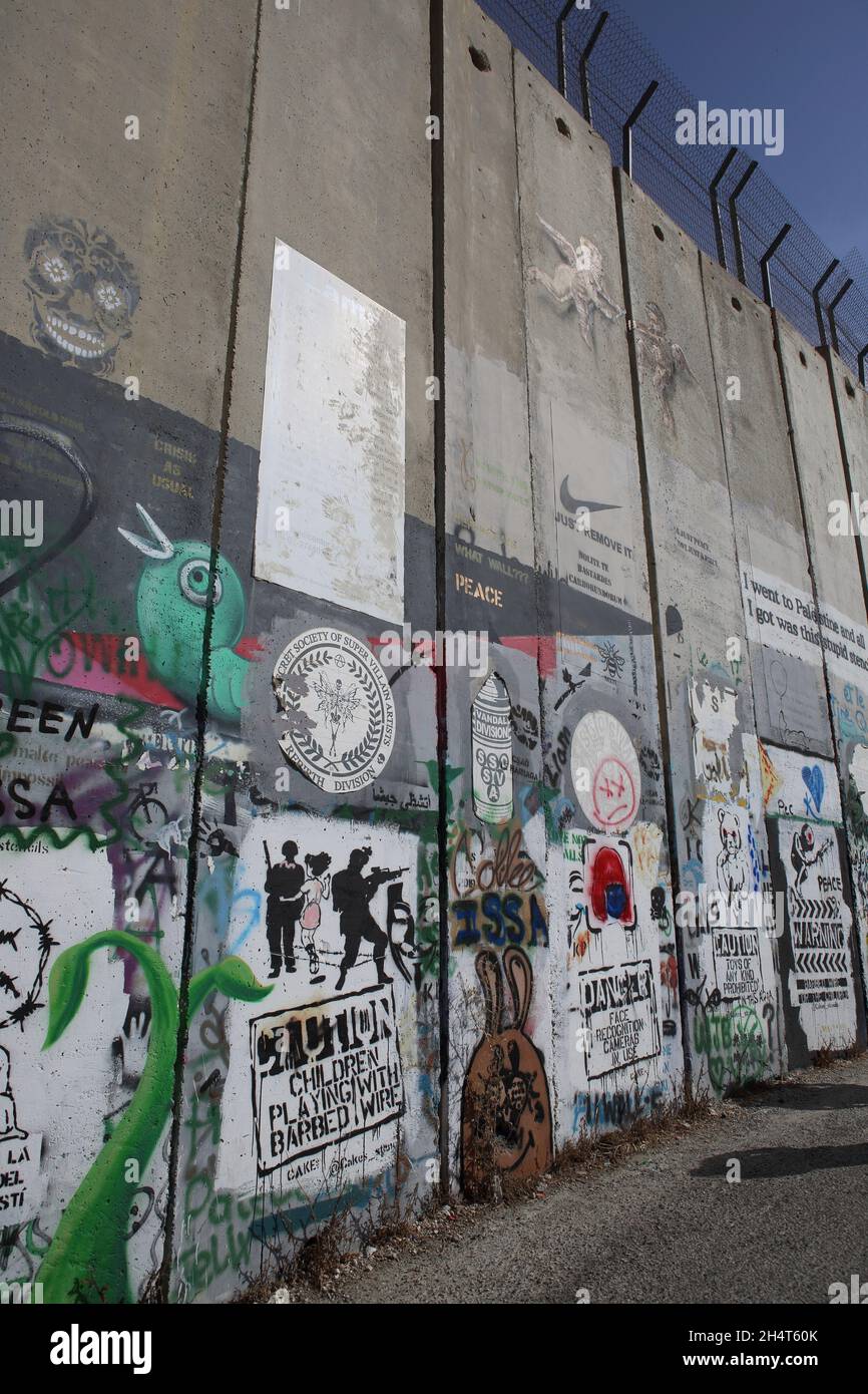 Political graffiti painted on the Palestinian side of the Wall of ...