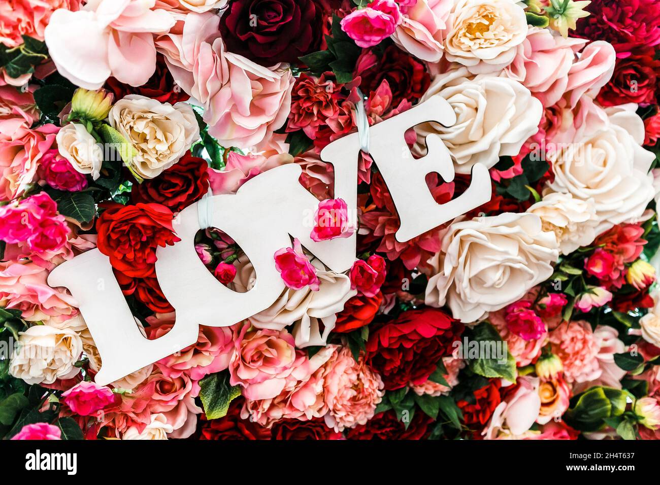 "Love" sign surrounded by flowers Stock Photo - Alamy