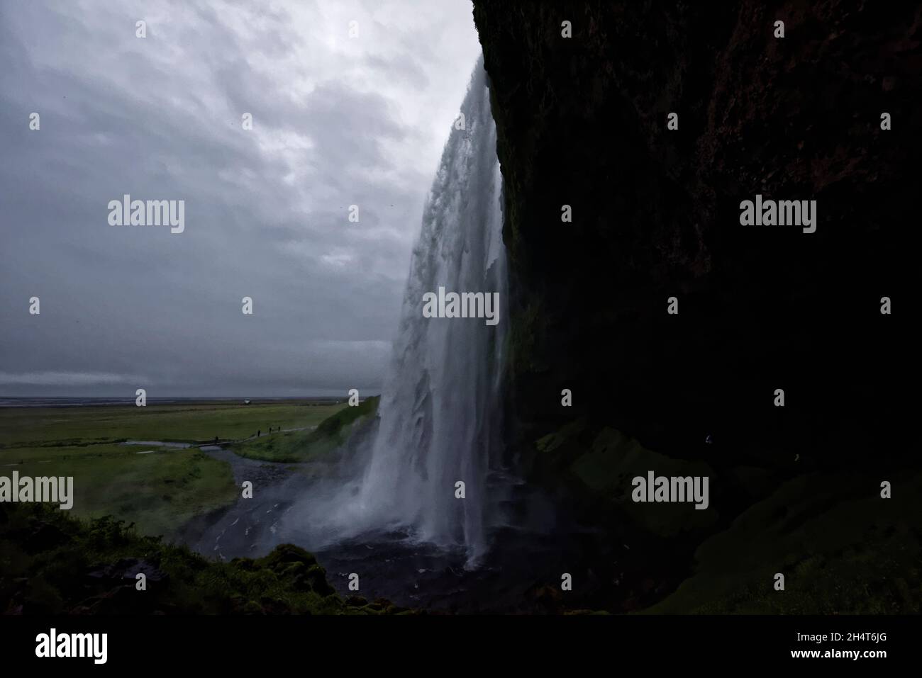 Seljalandsfoss waterfall plunging 60m from the cliff above, Sudhurland ...