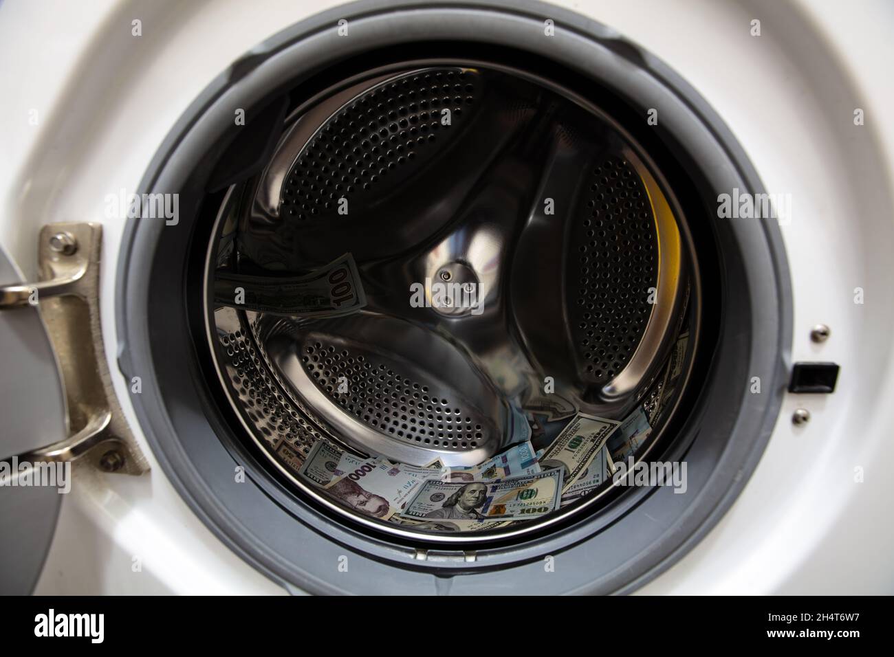 US dollar and Ukrainian hryvnia banknotes in washing machine Stock ...