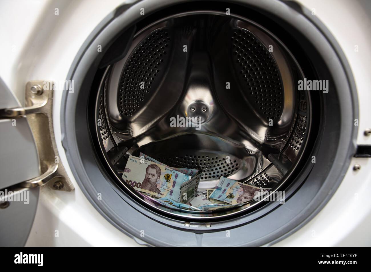 US dollar and Ukrainian hryvnia banknotes in washing machine Stock ...
