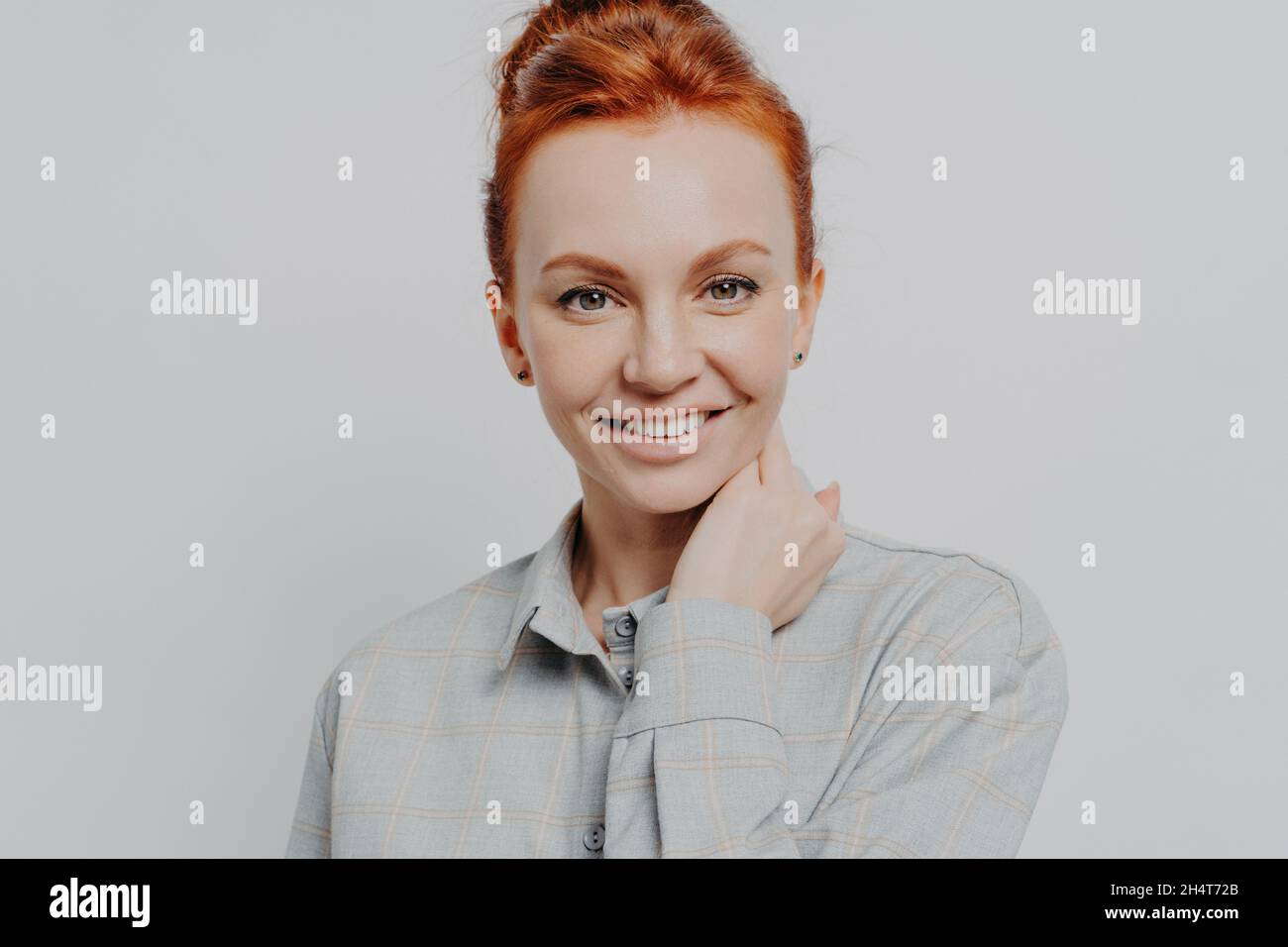 Happy redhead woman looking at camera white toothy smile isolated over ...