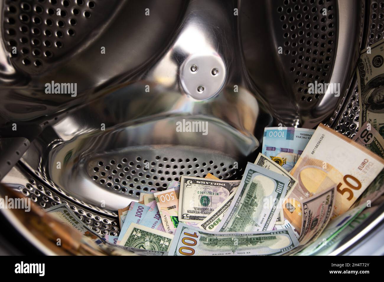 US dollar, Ukrainian hryvnia and euro banknotes in washing machine ...