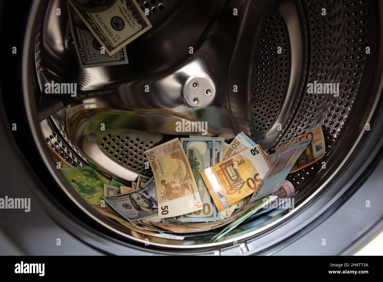 US dollar, Ukrainian hryvnia and euro banknotes in washing machine ...