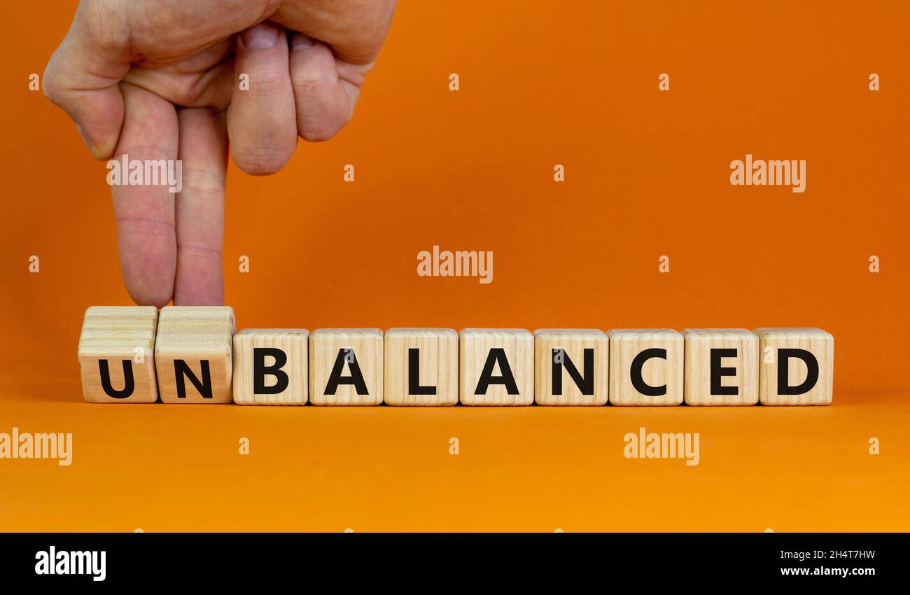 Balanced or unbalanced symbol. Businessman turns cubes, changes words ...