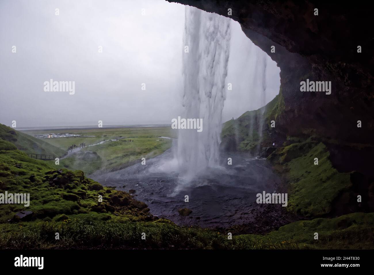 Seljalandsfoss waterfall plunging 60m from the cliff above, Sudhurland ...