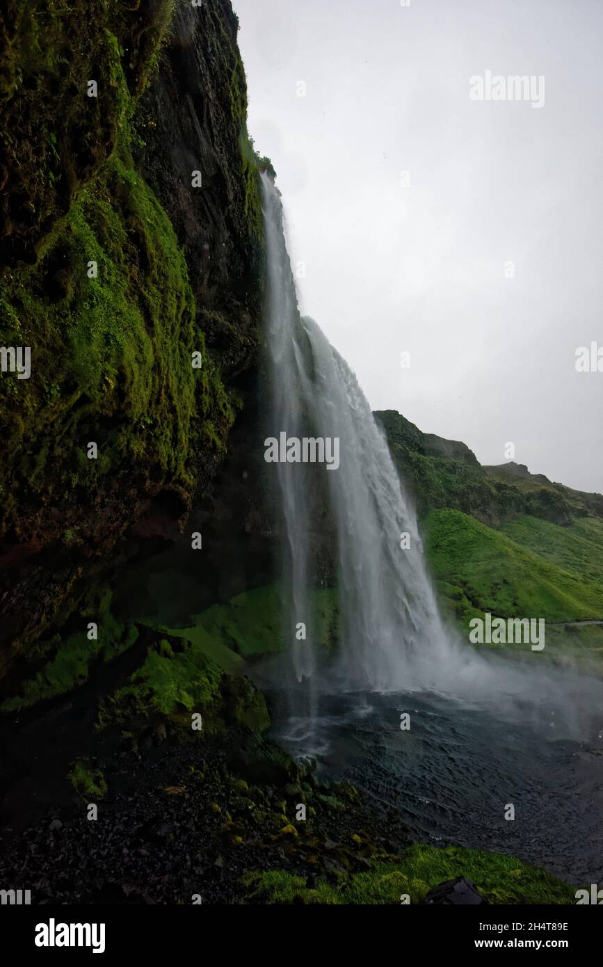 Seljalandsfoss waterfall plunging 60m from the cliff above, Sudhurland ...
