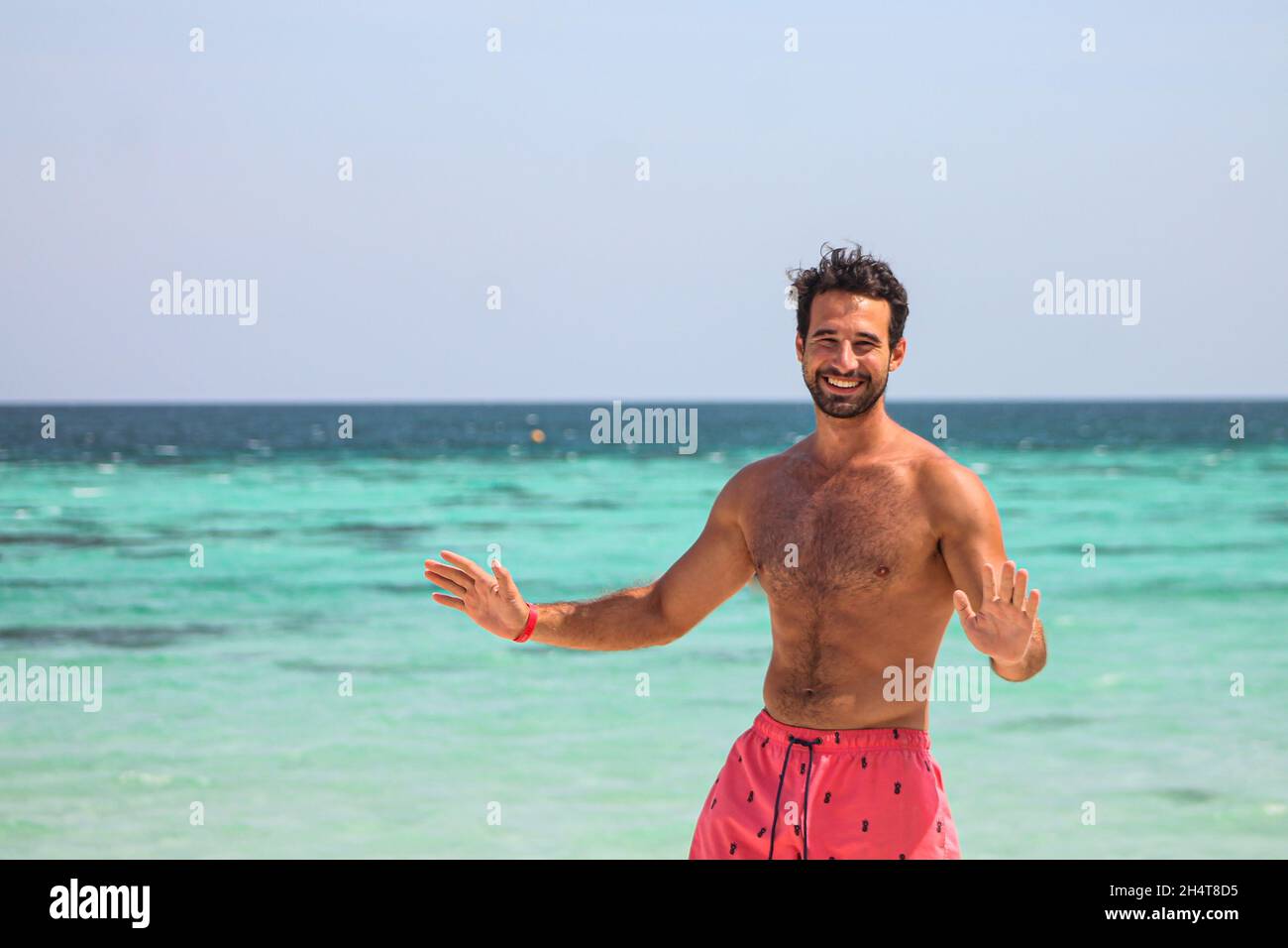 Handsome guy smiling on the beach Stock Photo - Alamy