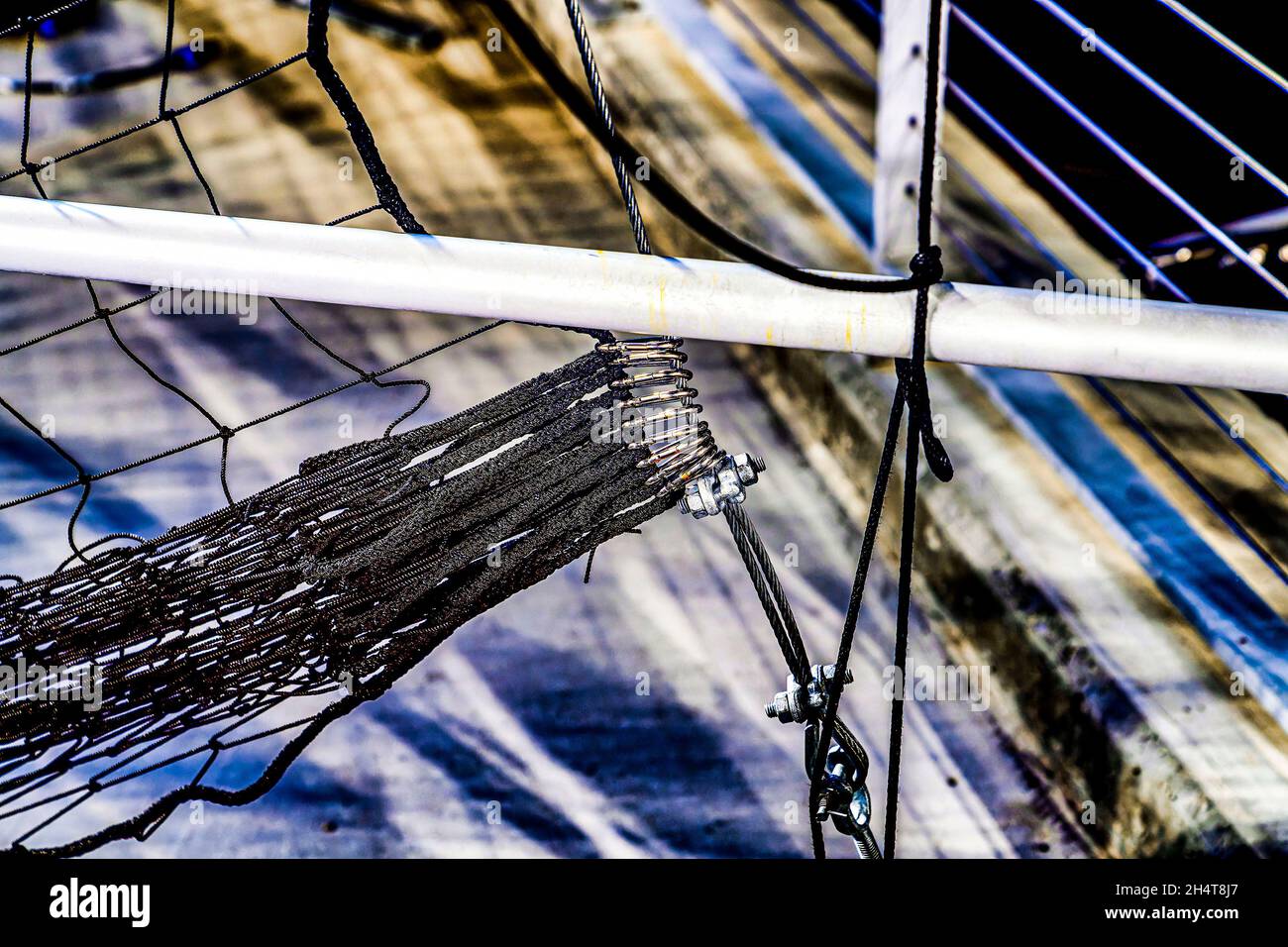 Lanyards tied by clasps to a taut wire Stock Photo - Alamy
