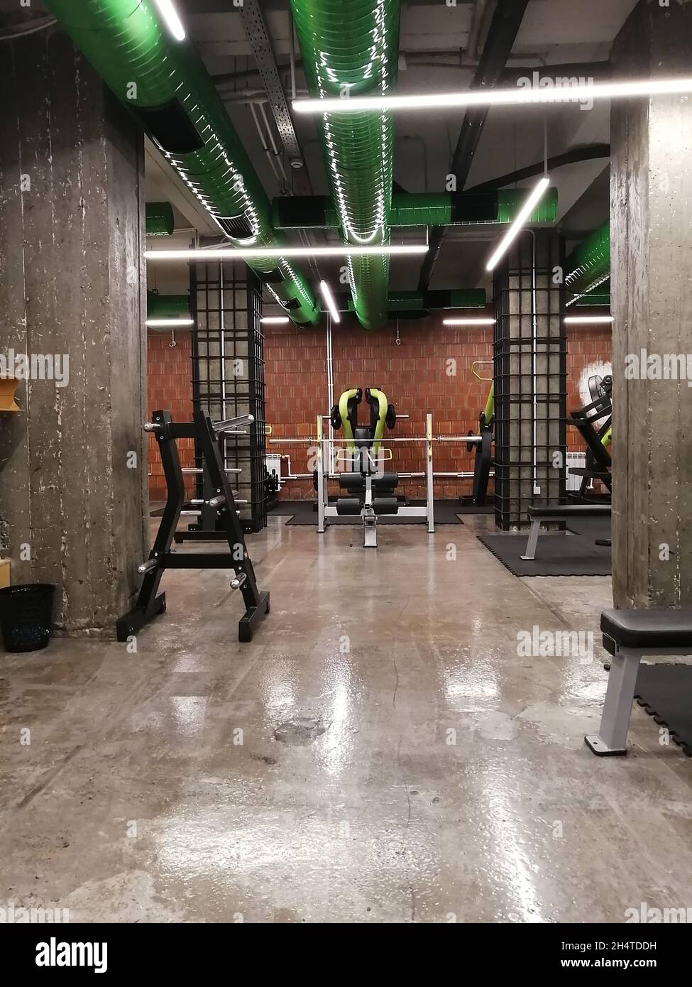 Vertical shot of an empty gym with columns and bright lighting Stock ...