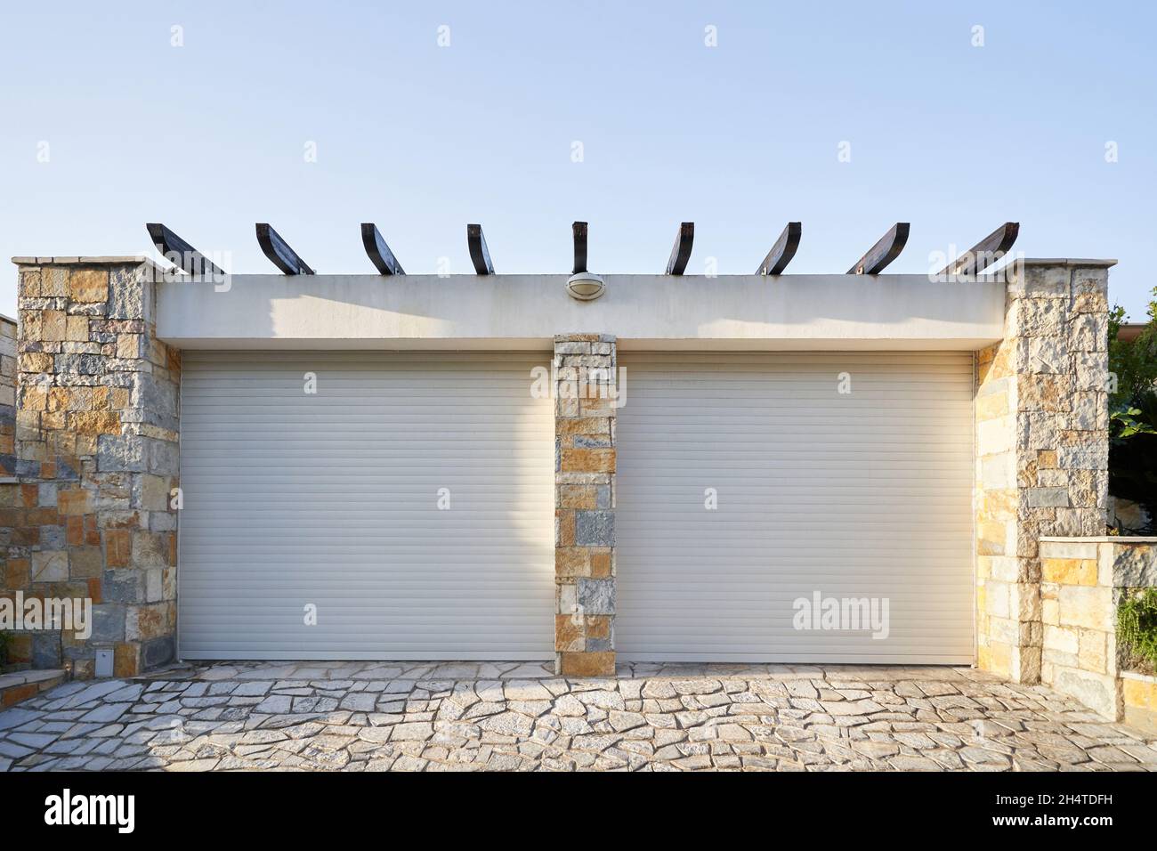 Modern private garage with white automatic rolling doors for 2 cars ...
