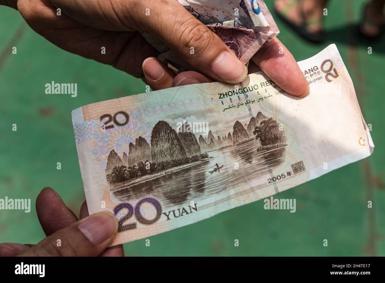 The 20 Yuan banknote has a scene of the Li River with a fisherman on ...