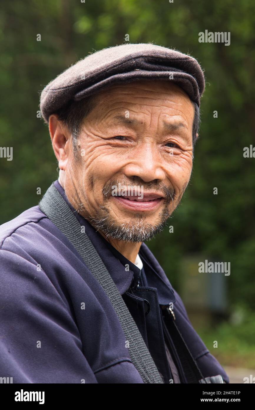 An older Chinese man poses for a portrait in Zhangjiajie National ...