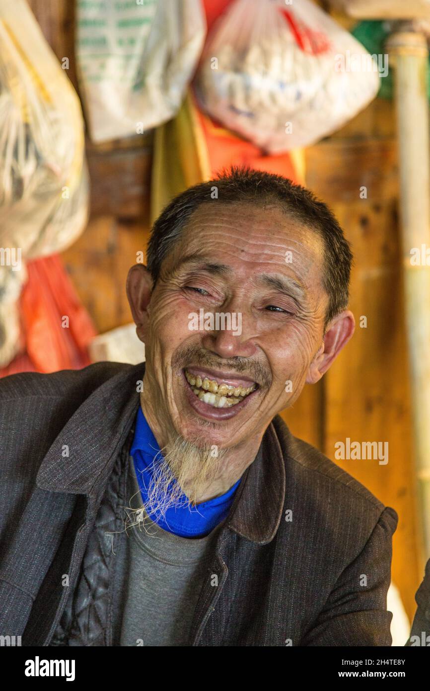 An older Chinese man selling traditional herbal medicines by a trail in ...