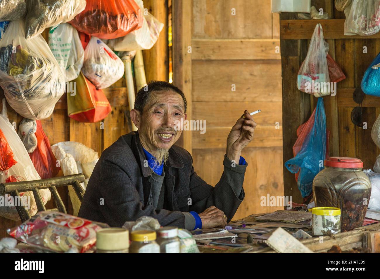 An older Chinese man selling traditional herbal medicines by a trail in ...